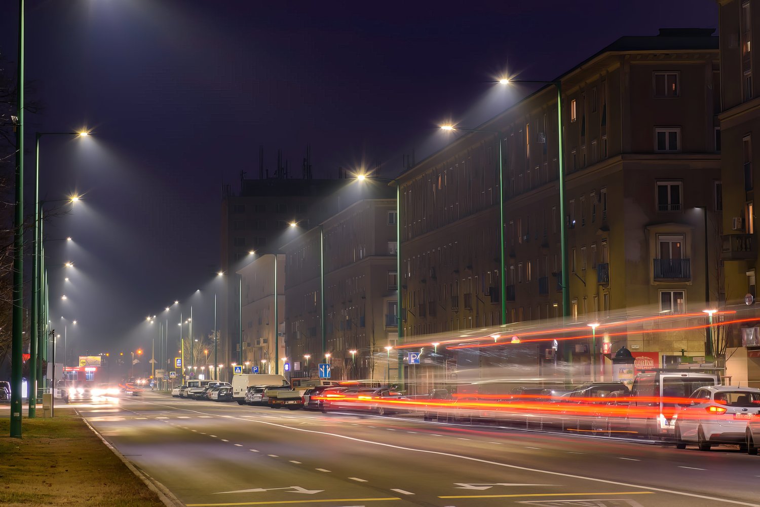 Night city street with car light trails in foggy atmosphere - Payhip