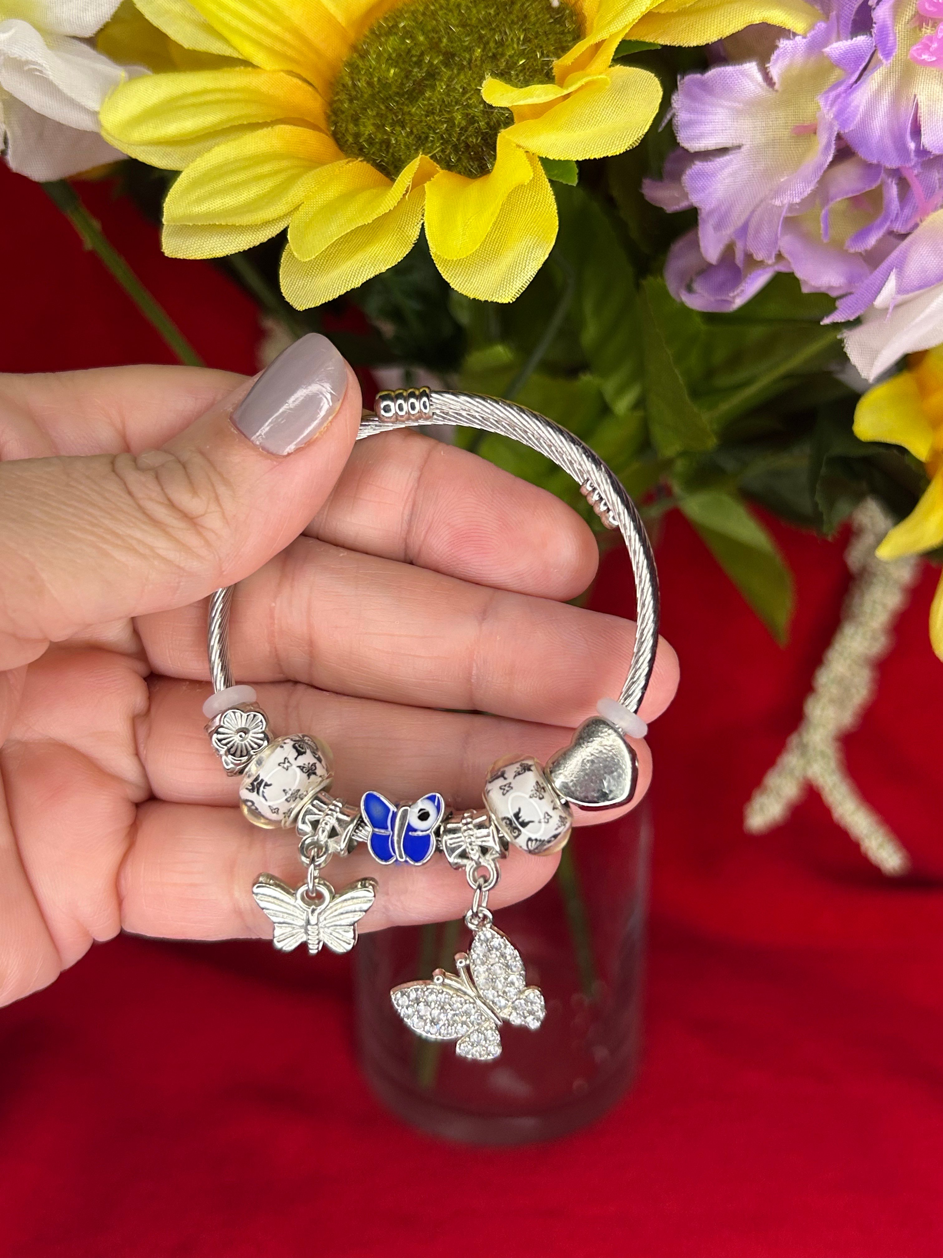 Stainless steel Pandora-style bracelet with floral-patterned beads ...